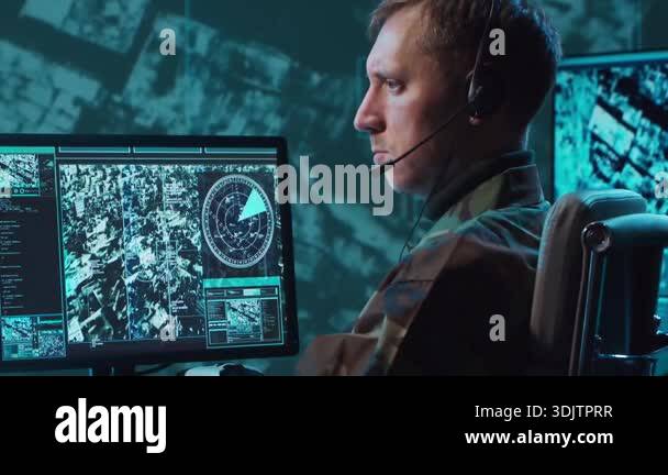 Soldier in a dimly lit military control room, intensely focused on ...