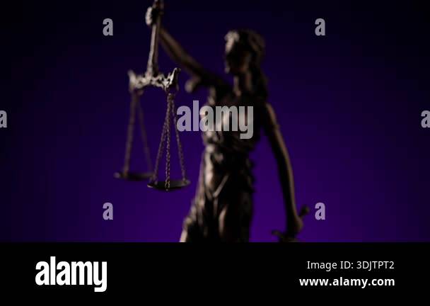 Rack focus shot slowly revealing the bronze statue of Lady Justice ...