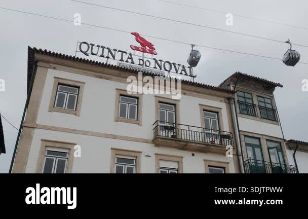 PORTO, PORTUGAL - OCTOBER 22 2025: Cable cars over Wine shop Quinta do ...
