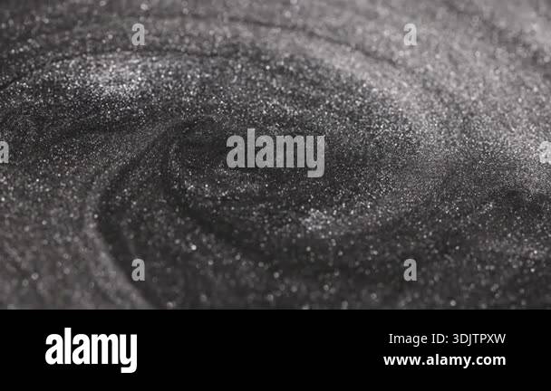 Detailed close-up of dark titanium paint swirling continuously into a ...