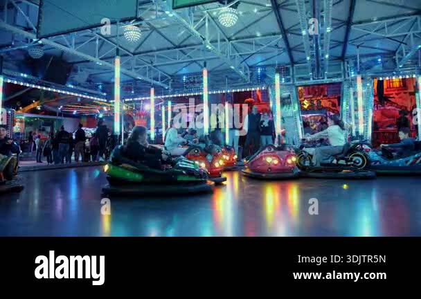 Bumper cars attraction under bright lights of a nighttime amusement ...