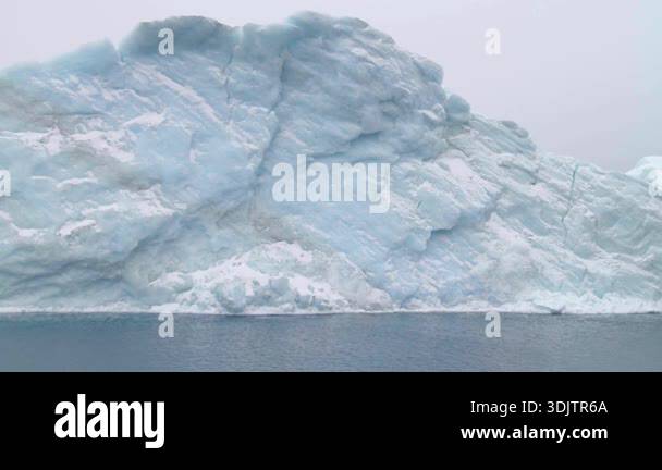 Massive Arctic iceberg wall in Greenland with blue ice texture over ...