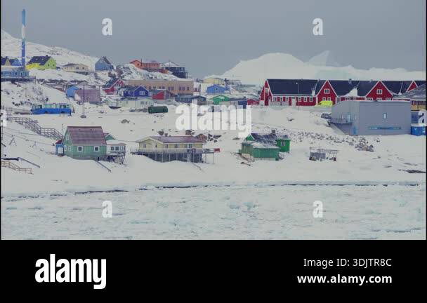 Arctic coastal village with colorful houses and fishing boats ...