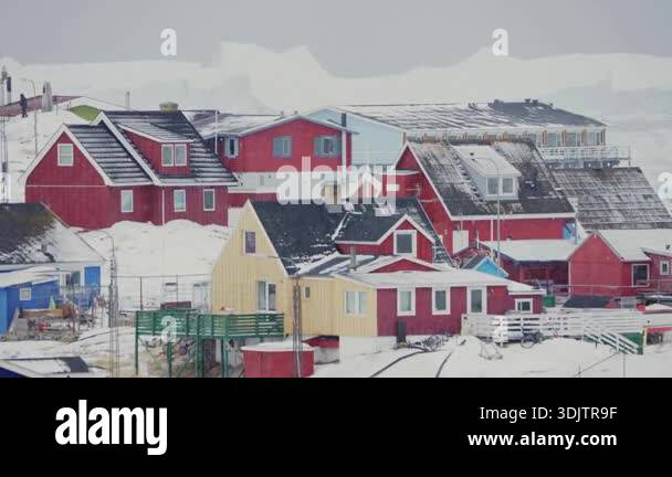 Colorful Arctic houses in a snow-covered coastal village in Greenland ...