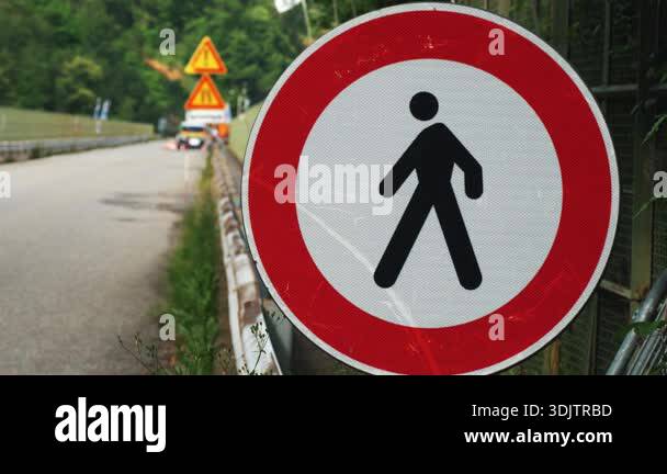 Close up of no pedestrian traffic sign against bridge and road works ...