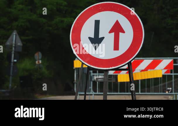 Road sign regulating oncoming traffic flow. Close-up of sign in round ...