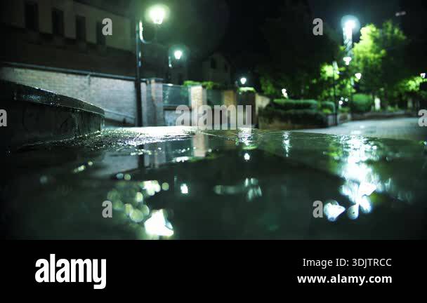 Powerful lightning strike illuminating night city sky during heavy ...