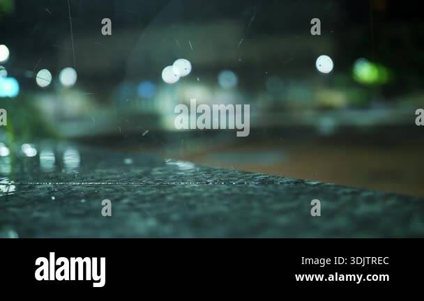 Powerful lightning strike illuminating night city sky during heavy ...