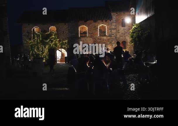 Evening restaurant in castle courtyard with decorative lighting and ...