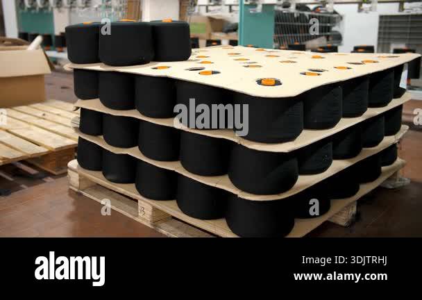 Industrial textile warehouse interior with organized storage of yarn ...