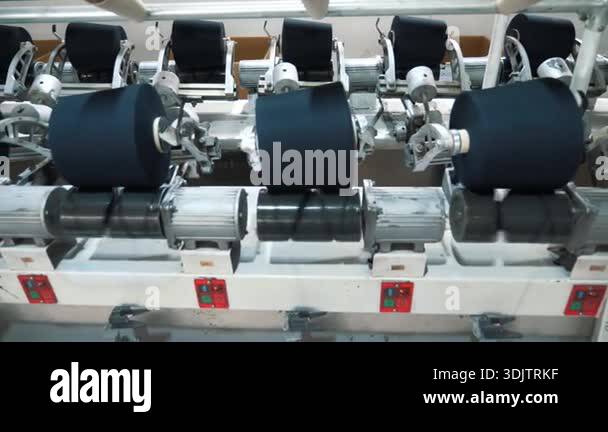 Textile factory equipment processing yarn spools with automated ...