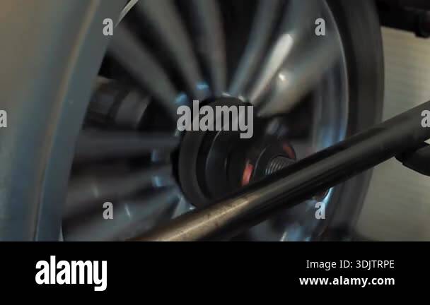 Tire balancing process on specialized stand ensuring safety. Vehicle ...