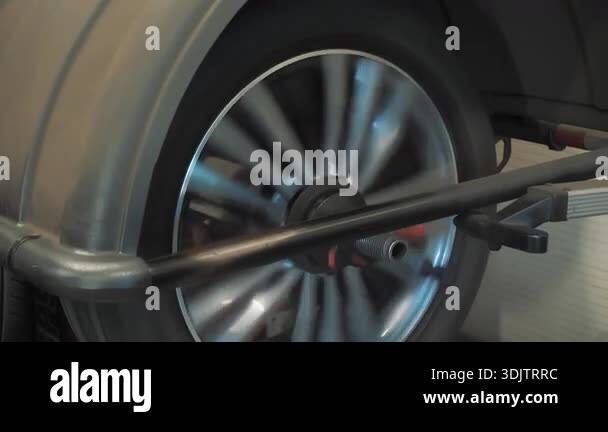 Car wheel spinning rapidly on balancing machine during tire fitting ...