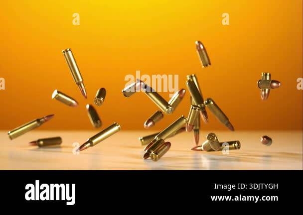 Multiple brass rifle and pistol bullets falling and bouncing on a white ...