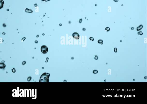 Countless small crystal clear water droplets falling and scattering ...