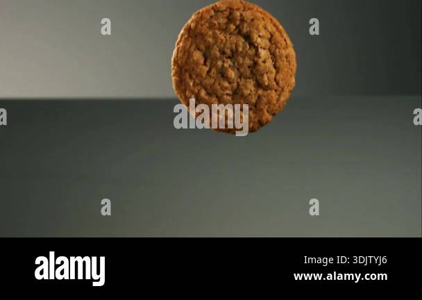 Oatmeal cookies and snickerdoodles falling and bouncing on a dark ...