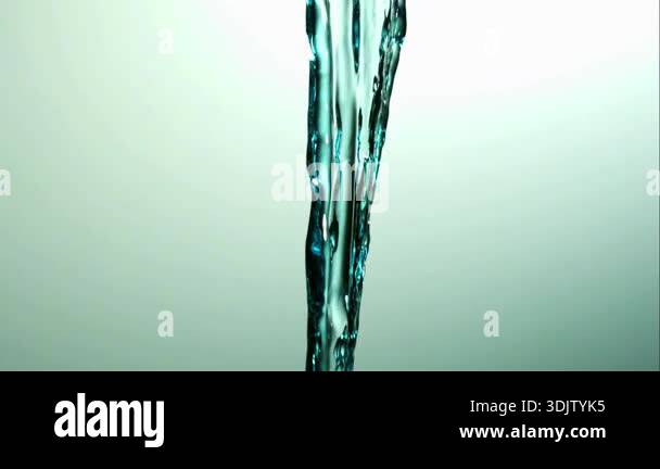 Single vertical stream of crystal clear water flowing downwards with ...
