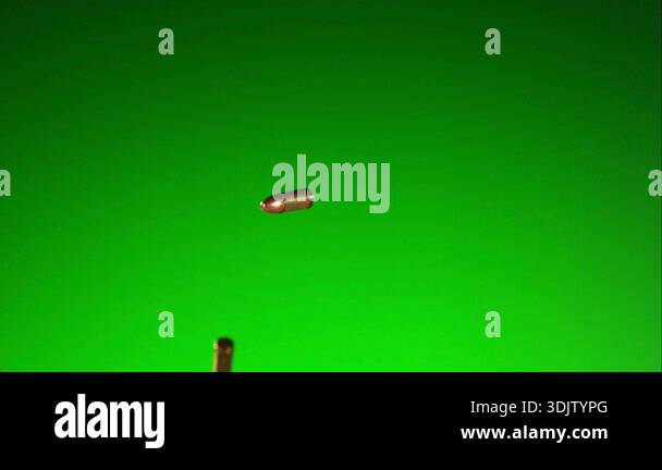 Shiny metal bullets falling through the air in slow motion against a ...