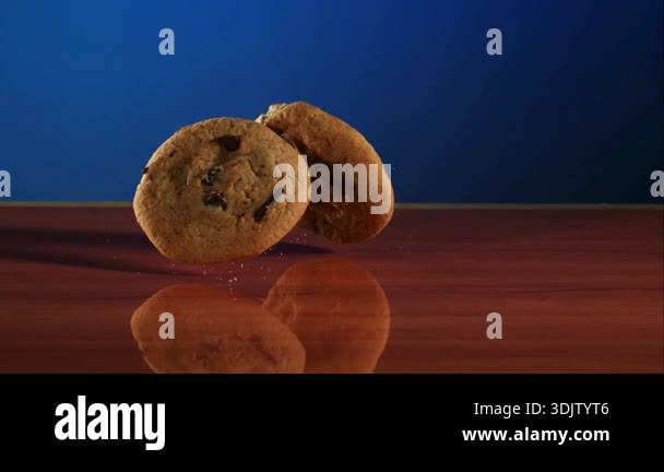 Two delicious chocolate chip cookies falling down and bouncing on a ...