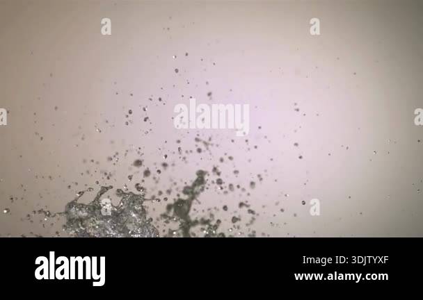 A massive water splash exploding upwards and dissipating into small ...