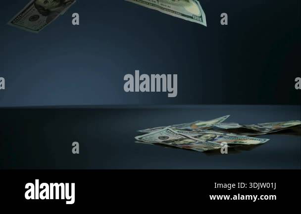 Pile of one hundred dollar bills falling down from the sky onto a dark ...