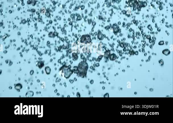 Crystal clear water droplets and streams falling vertically through the ...