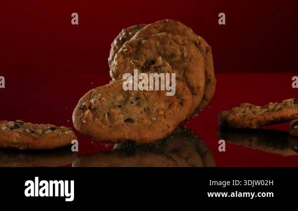 A stack of delicious oatmeal raisin cookies falling and tumbling onto a ...