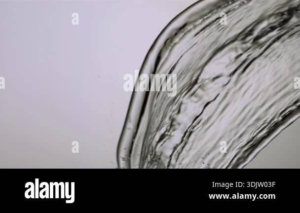 Fresh red raspberries falling into a fast moving stream of clear water ...