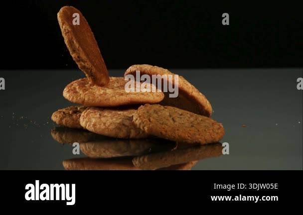 Freshly baked round ginger snaps and oatmeal cookies falling and ...