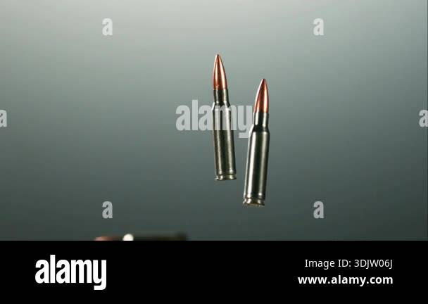 Heavy metal rifle cartridges and bullets falling through the air and ...