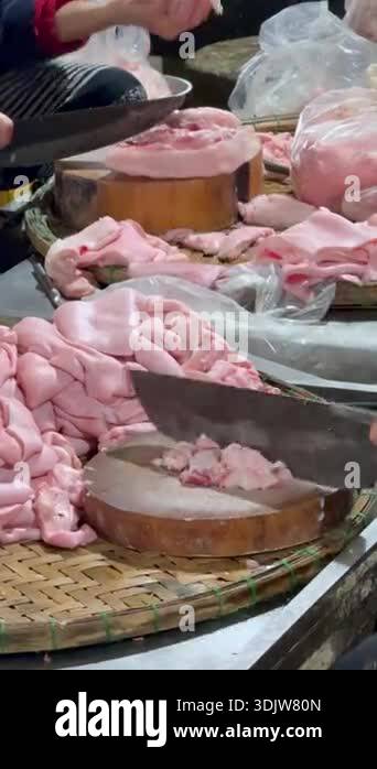 Raw pork meat chopped by vendor at traditional wet market in Vietnam ...
