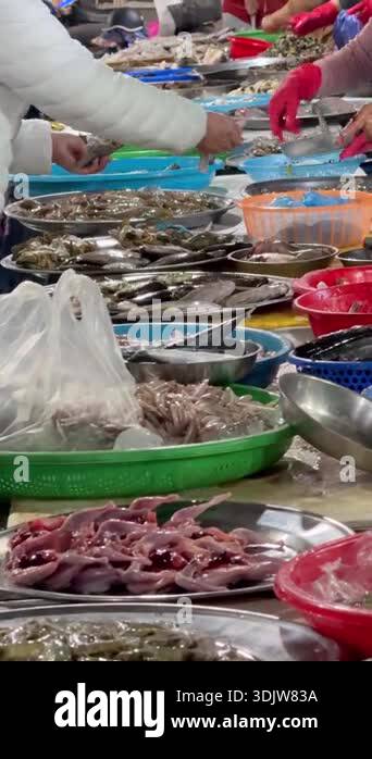 Fresh fish and seafood sold at traditional wet market in Vietnam. Local ...