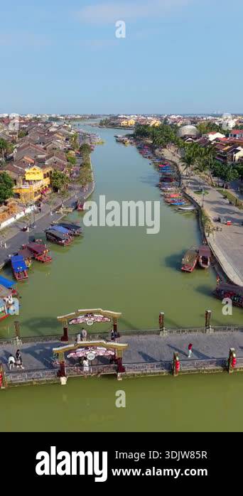 Aerial view of bridge crossing the river in Hoi An old town, with ...