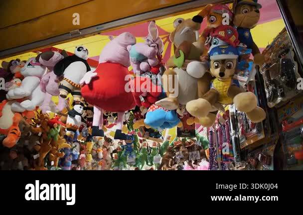 Various soft toys hanging as prizes at a game booth in an Italian ...