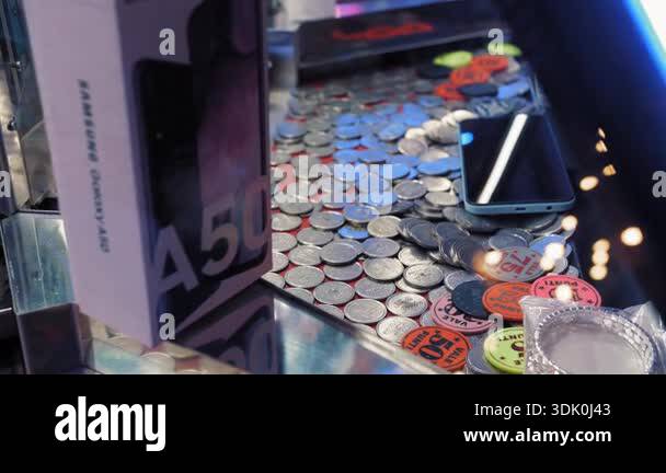 Two pence coins stacked in a penny falls machine at an Italian arcade ...