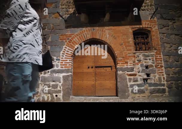 Mother and daughter walking around territory of ancient Italian castle ...