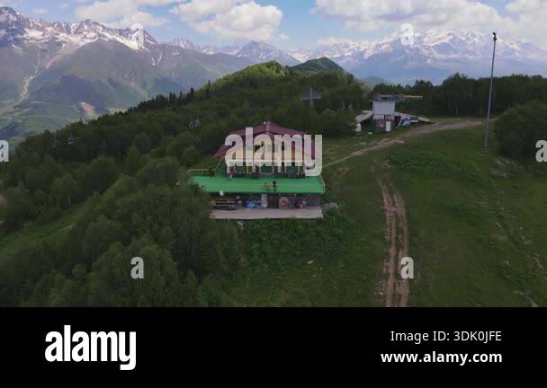 Aerial view of a red roof mountain lodge in Svaneti, Georgia, with ...