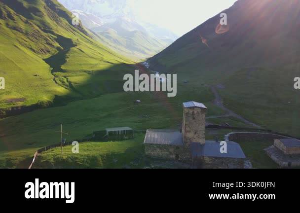 Aerial drone shot in Upper Svaneti, Georgia follows a winding stream ...