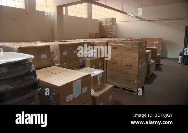 Heavy industrial machinery operating in a textile warehouse processing ...