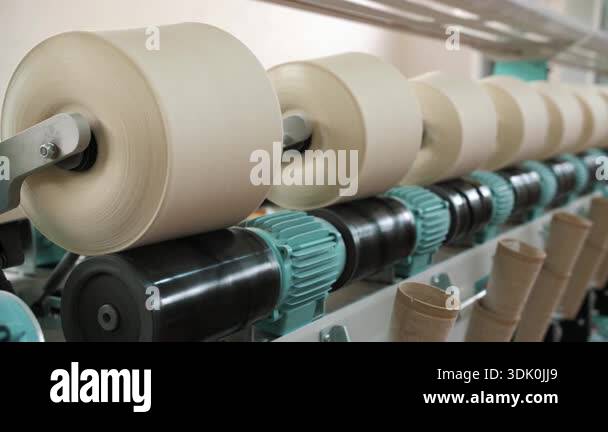 Detailed close up view of yarn spools during textile manufacturing ...