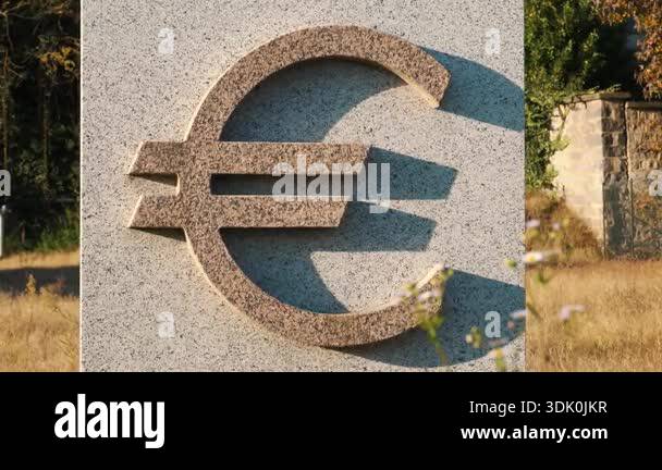Euro currency symbol carved from marble and set on a marble plate ...