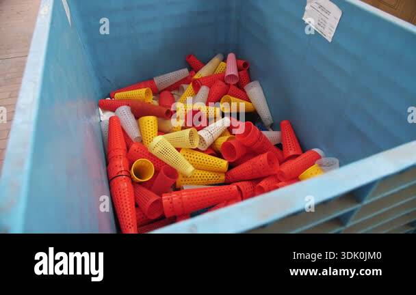 Assortment of perforated yarn cones in a storage container at a textile ...