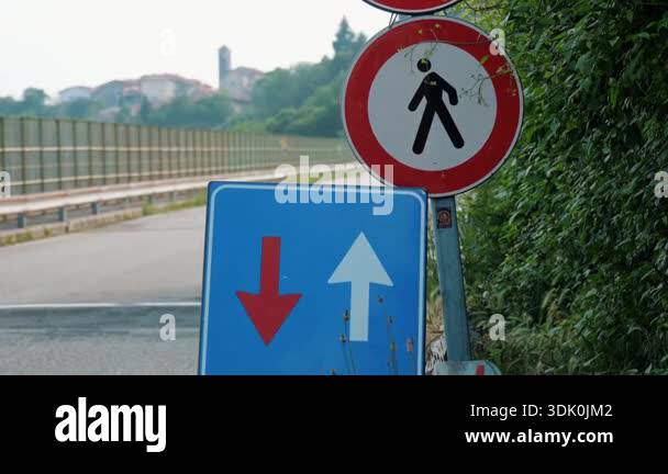 Blue square traffic sign with red and white arrows. Close-up of ...