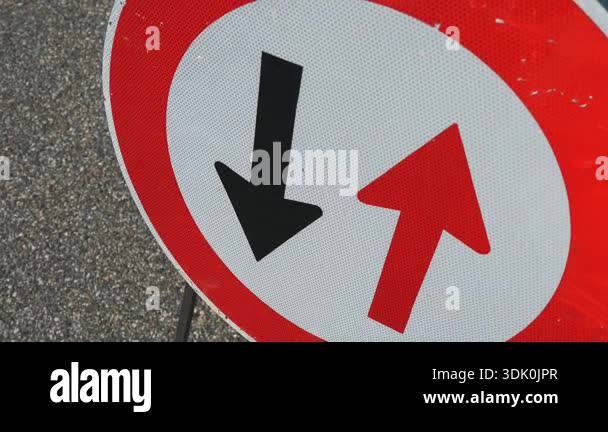 Priority road sign in red circle against asphalt background. Indication ...