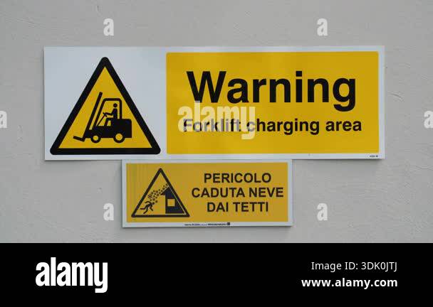 Yellow danger warning signs attached to industrial machinery in a ...
