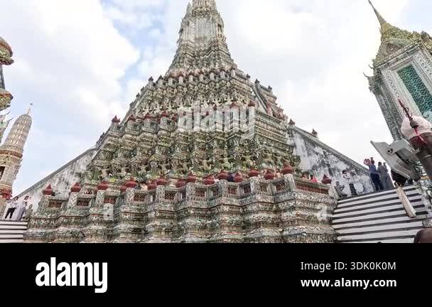 A dynamic view of Wat Arun, showcasing its intricate architecture under ...