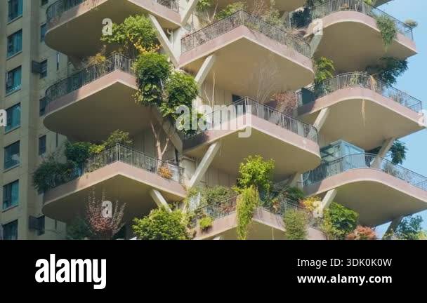 Close up view of modern residential building with lush green plants ...