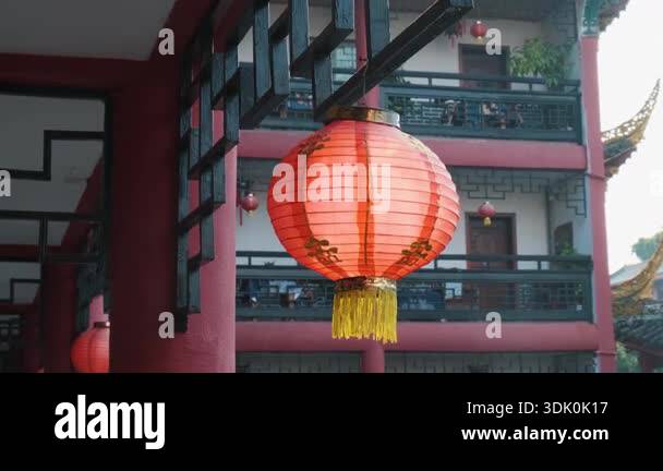 Traditional red Chinese lantern hanging outside a building with Asian ...