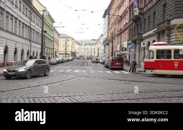 Winter day on Vienna cobblestone street with cars and people Stock ...