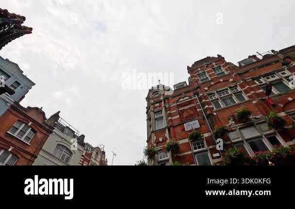 People walking past vibrant buildings and decorations Stock Video ...